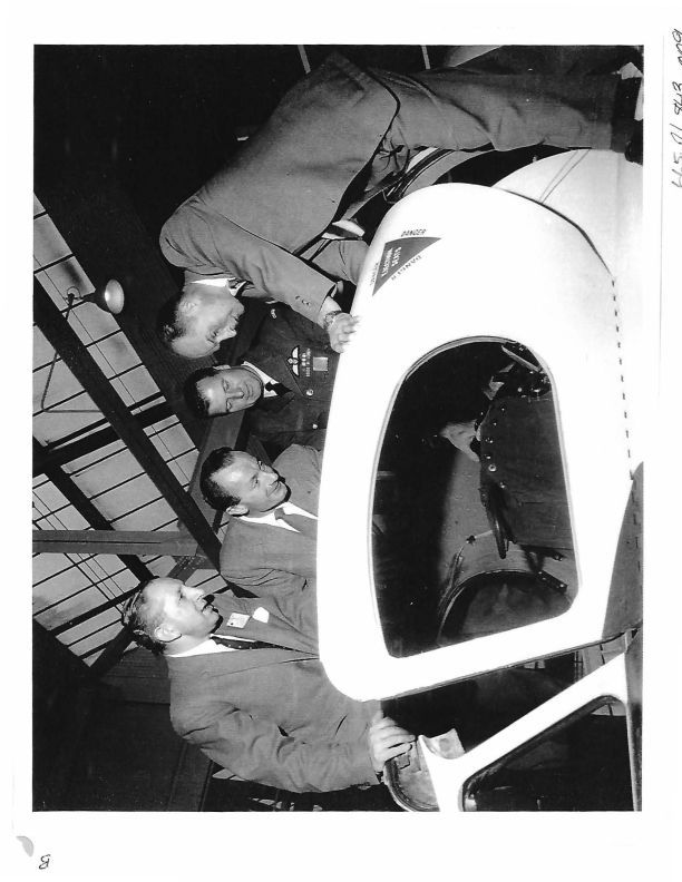 Photo of 4 Test Pilots looking into Cockpit of Arrow